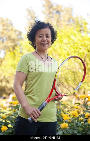 Picture of Smiling sports woman doing crossfit exercise and looking ...