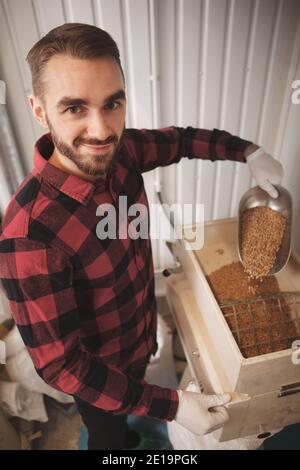 Top view shot of a male brewer tasting beer at his microbrewery, copy ...