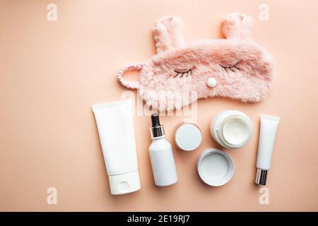 Cosmetic white containers with sleeping mask on pink background top ...