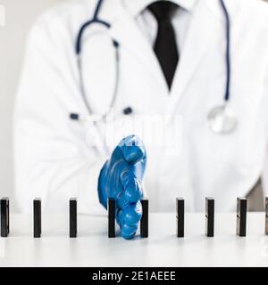 close up. doctor using dominoes to show a safe distance Stock Photo - Alamy