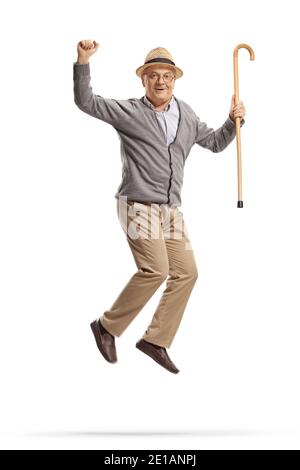 Elderly man with a cane jumping and gesturng happiness isolated on ...