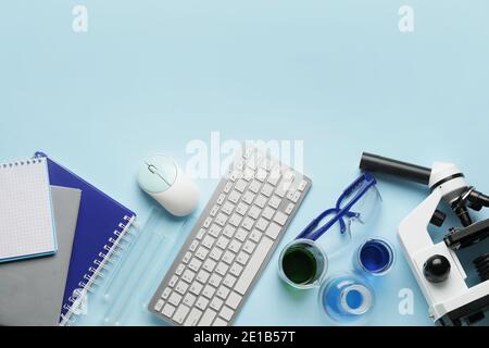 Composition with computer keyboard, mouse and microscope on white ...
