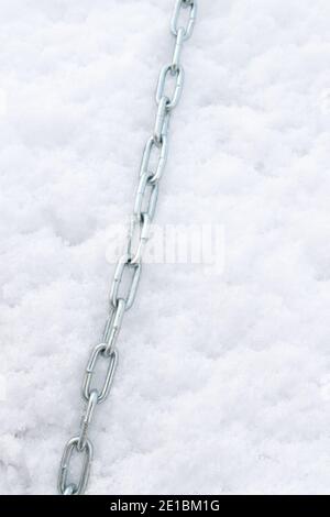 A metal chain lies on the snow in winter Stock Photo - Alamy