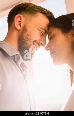 Portrait loving couples enjoying each other company with window in ...