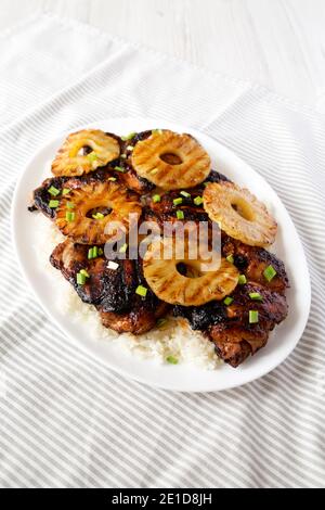 Homemade Hawaiian Huli Huli Chicken on a white plate on a white wooden ...