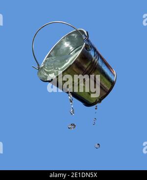 A falling buckets splashes water, on a background of blue sky Stock ...