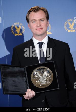 Christopher Nolan poses in the press room with the award for best ...