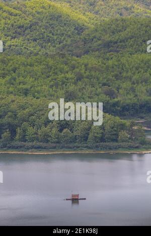 raft floating in dam againts mountain Stock Photo - Alamy