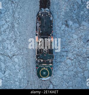 Ship sails on an ice-bound bay. Winter seafaring Stock Photo - Alamy