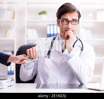 The doctor in corruption concept with being offered bribe Stock Photo ...