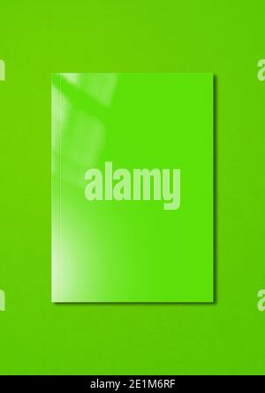 Green booklet cover isolated on dark concrete background, mockup ...