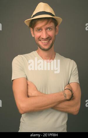 Studio shot of blond bearded tourist man against gray background Stock ...