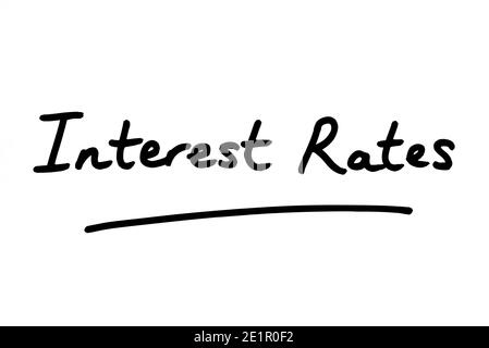 Interest rates written on white piece of paper, model house and money ...
