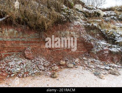 Textured red and white clay outcrop in the sea cliffs. Sandstones and ...