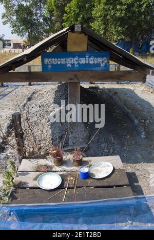 Plates hold offerings and incense sticks at the grave of Cambodian ...
