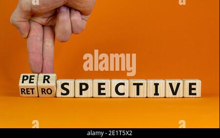 Perspective or retrospective symbol. Businessman hand turns cubes and ...