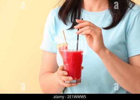 Woman with glass of fresh watermelon juice on color background Stock ...