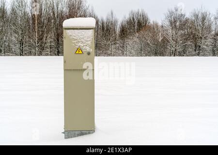 Outdoor Electric cabinet on the snow field. Old electrical cabinet in ...
