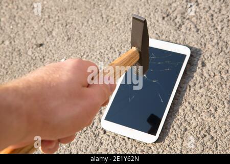 hammer smashing the screen of a smartphone Stock Photo - Alamy