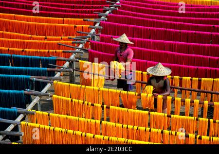 Weavers rinse the colourful Jute fibre to dry under sun which will be ...
