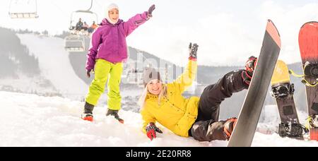 mother and daughter with snowboards at winter resort Stock Photo - Alamy