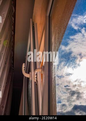 Open plastic window handle. Half open window ventilation Stock Photo ...