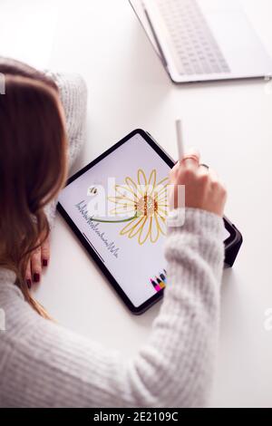 Overhead view of businesswoman using tablet computer while sitting at ...