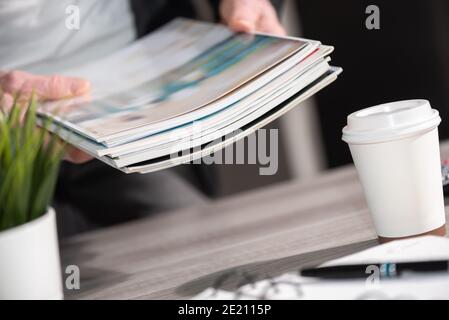 Male hands holding a stack of magazines; multiple exposure Stock Photo ...