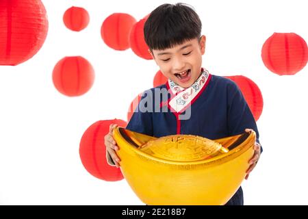 Lovely boy holding gold ingot Stock Photo - Alamy