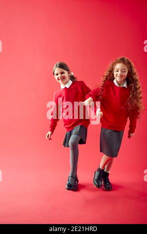 Friends linking arms back to back Stock Photo - Alamy