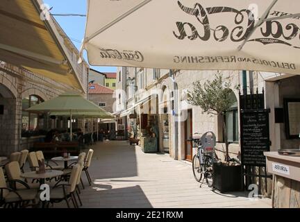 umbrellas shading the tables and chairs out side the cafe in the old ...