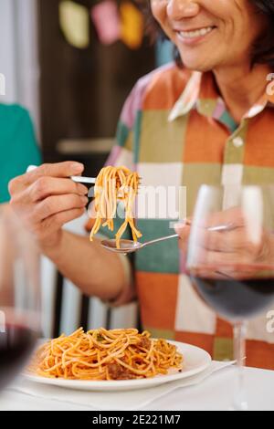 Senior man eating spaghetti at kitchen Stock Photo - Alamy