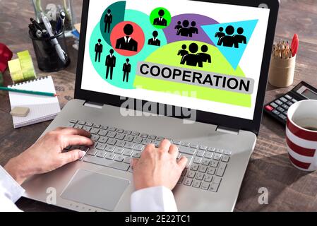 Cooperation concept shown on a laptop used by a man Stock Photo - Alamy