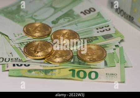 golden valuable bitcoins and many 100 euro bills view from above Stock ...