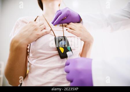 Woman Wearing Holter Monitor Device For Daily Monitoring Of An ...
