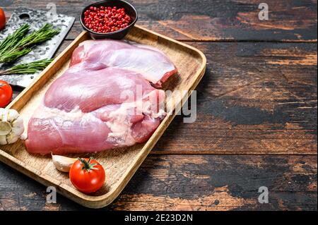 Raw fillet of farm Turkey thigh. Dark wooden background. Top view Stock ...