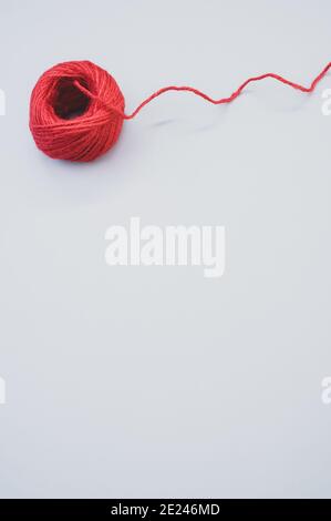 Vertical shot of bright red woolen yarn on a yellow background Stock ...