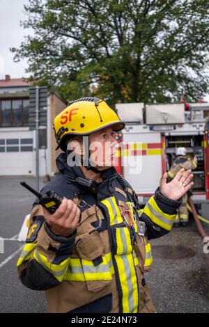 Firefighter talking via walkie talkie Stock Photo - Alamy