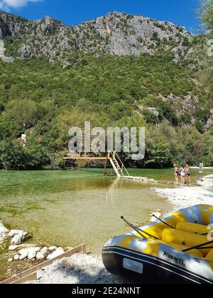 Unidentified tourist crossing the bridge in Mykines joining two sides ...