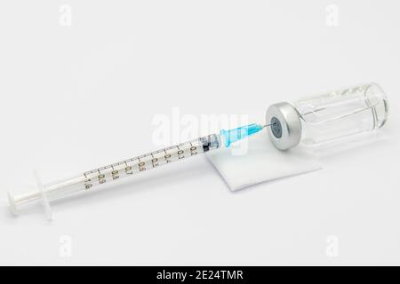 Insulin vial and uncapped syringe on white background with copy space ...