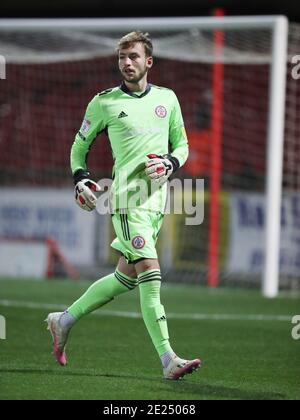 Accrington Stanley' goalkeeper Toby Savin makes a save at the feet of ...
