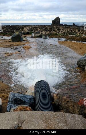 Sewage outlet pipe on beach at low tide in Worthing, West Sussex Stock ...