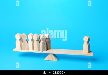 Human figurine has equal weight against a group of people Stock Photo ...