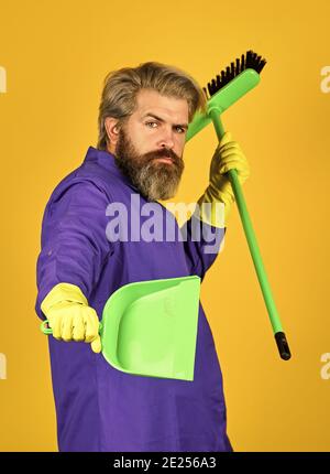 Janitor professional. Bearded hipster blue uniform with broom. Gardener ...