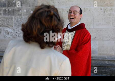 Priest greeting parishioners after Pentecost mass in St Nicolas's ...