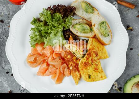 omelet with red fish and vegetables, beautiful serving Stock Photo - Alamy