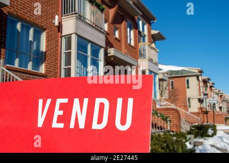 Vendu sign posted in front of houses. Vendu means Sold in french Stock ...