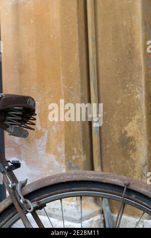 Close up of an old rusty bicycle. Drive chain is broken. Reflector on ...