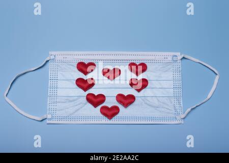 Sanitary mask and small red hearts decorations - Valentine's Day during ...