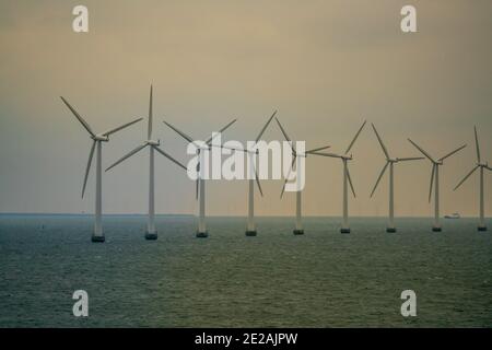 Massive offshore wind turbines generating clean green energy from ocean ...